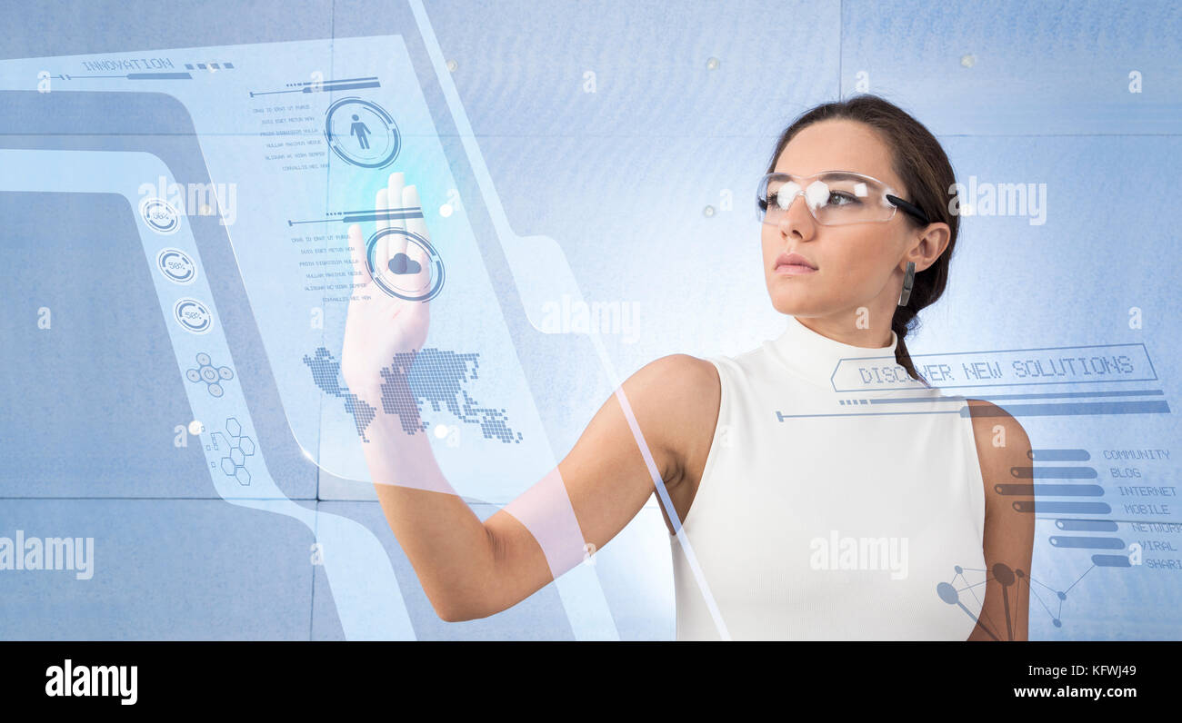 A young brunette woman in a white high-tech dress is wearing smart ...