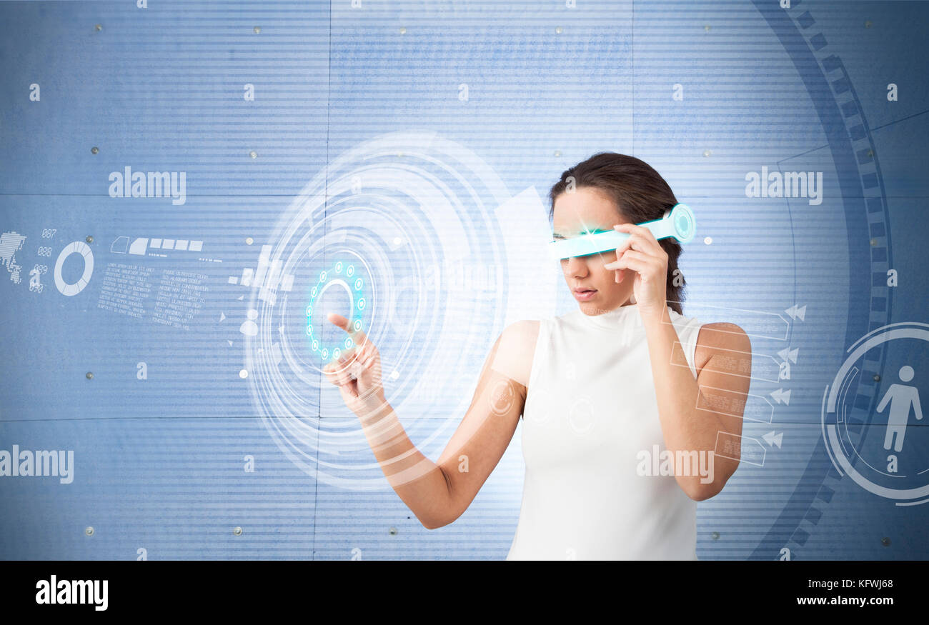 Young woman with smart-glasses touching the virtual future interface ...