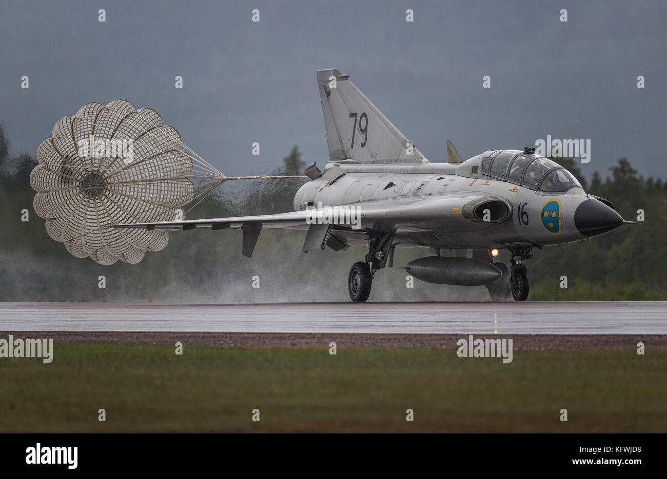 Saab SK35 Draken deploying a brake shute when landing in wet conditions ...