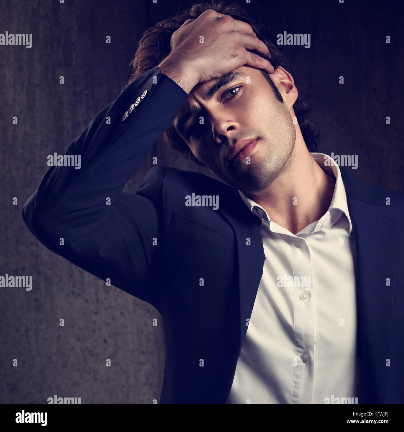 Charismatic tired handsome business man in blue fashion suit and white ...