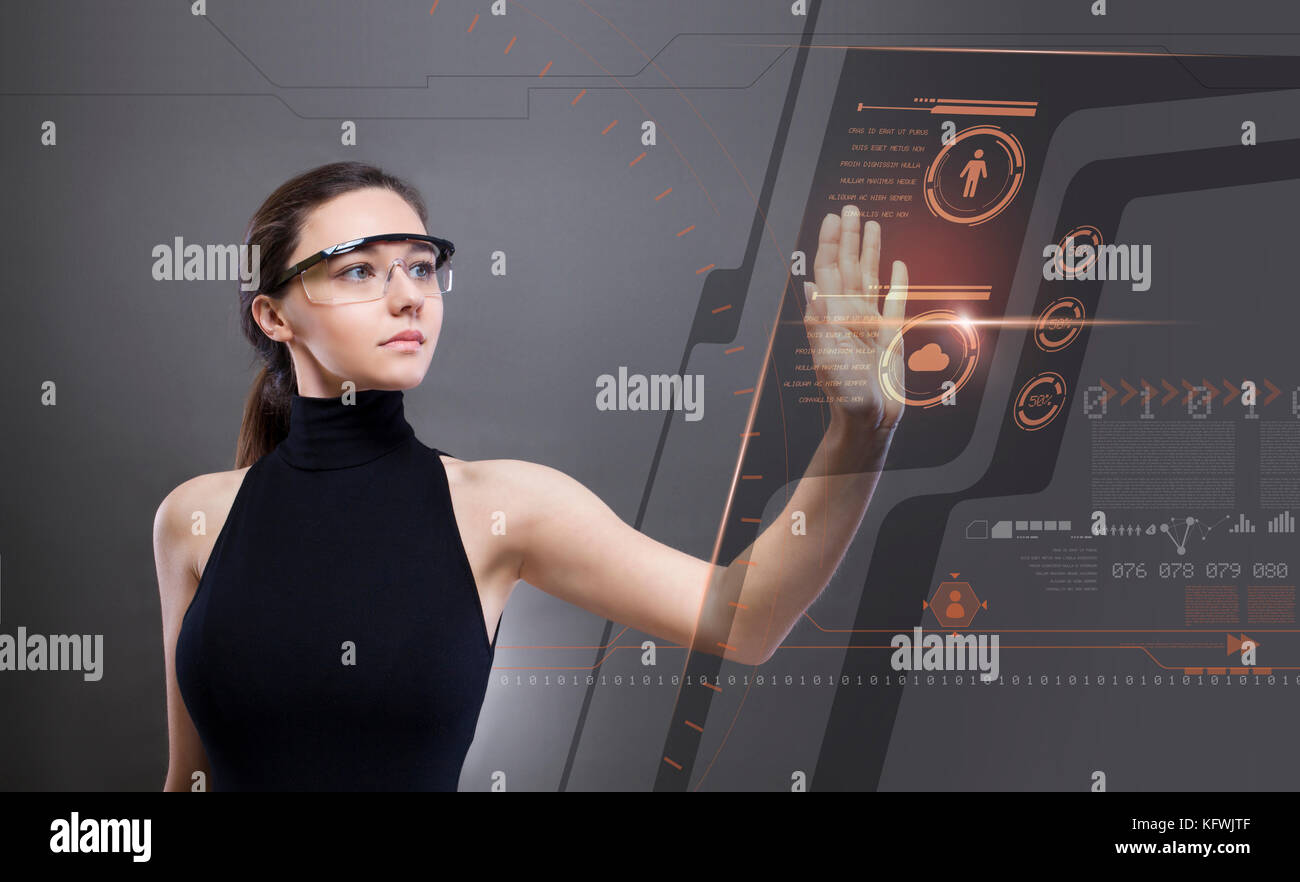 Young woman in a black high-tech dress is wearing smart glasses and ...