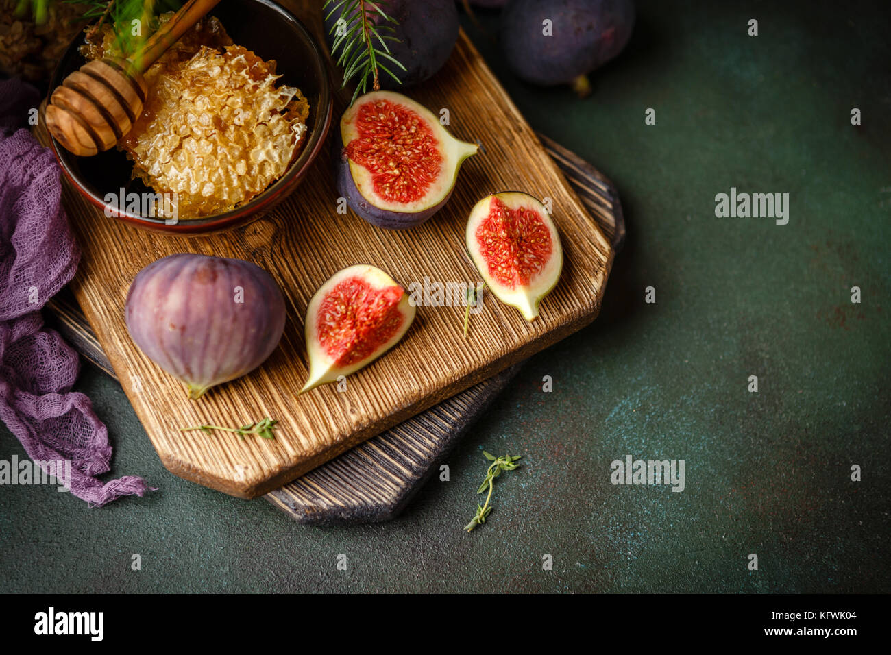 Juicy fresh whole fig fruits and one cut figs and bowl of honey in ...