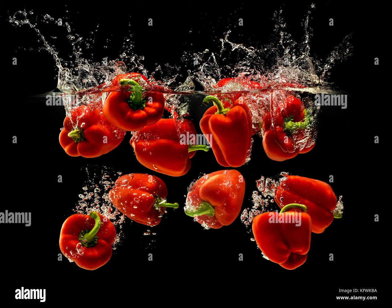 Red bell pepper falling in water Stock Photo - Alamy