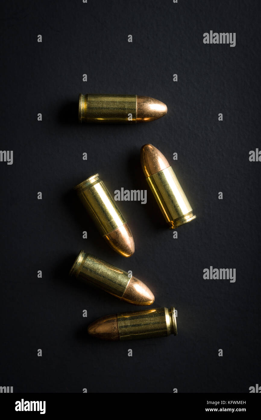 9mm pistol bullets on black table Stock Photo - Alamy