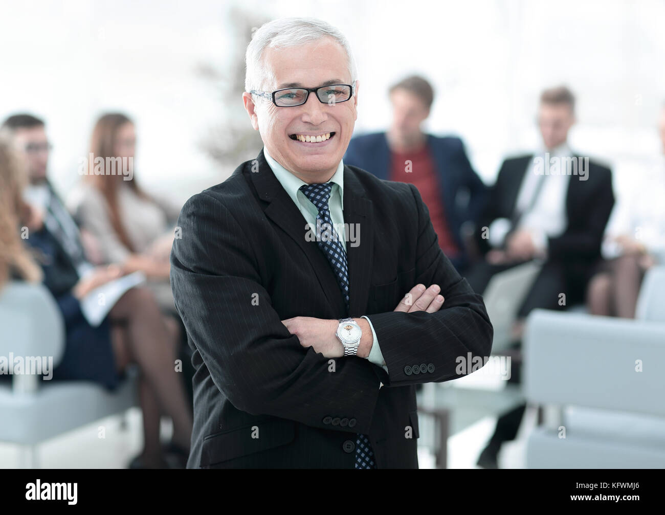 smiling senior boss in the background of the office Stock Photo - Alamy