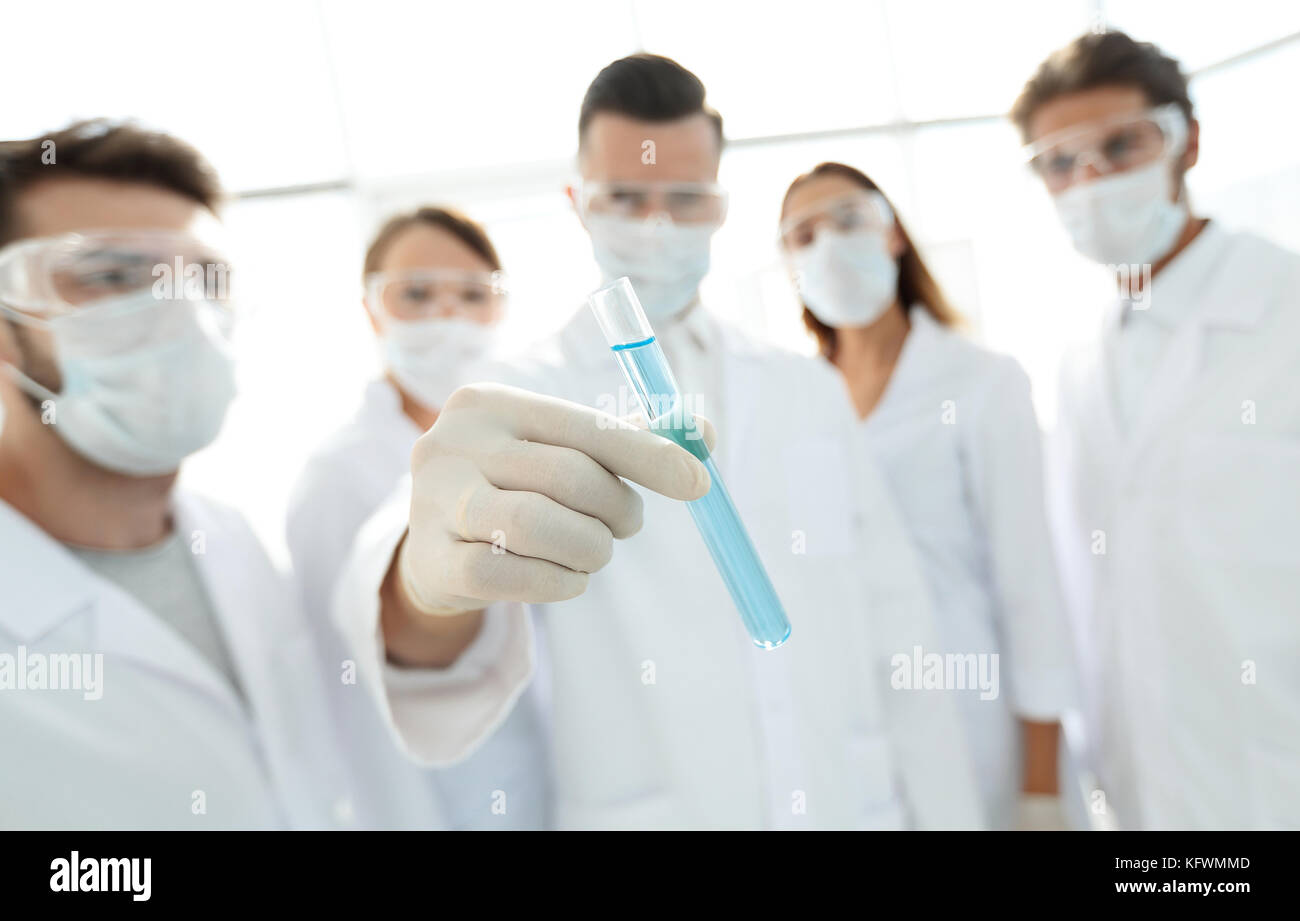 background image is a group of medical workers working with liquids in ...