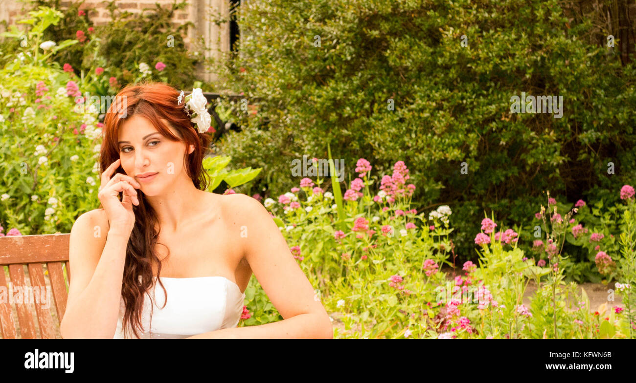 Bride in wedding dress with long brown hair Stock Photo - Alamy