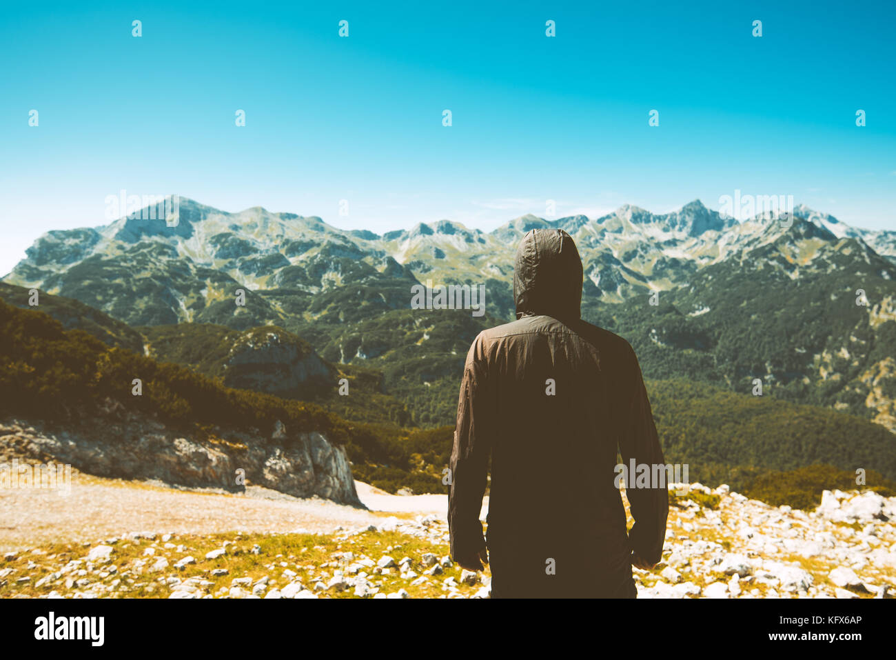 Mountain hiker looking into beautiful landscape. Rear view of the man ...
