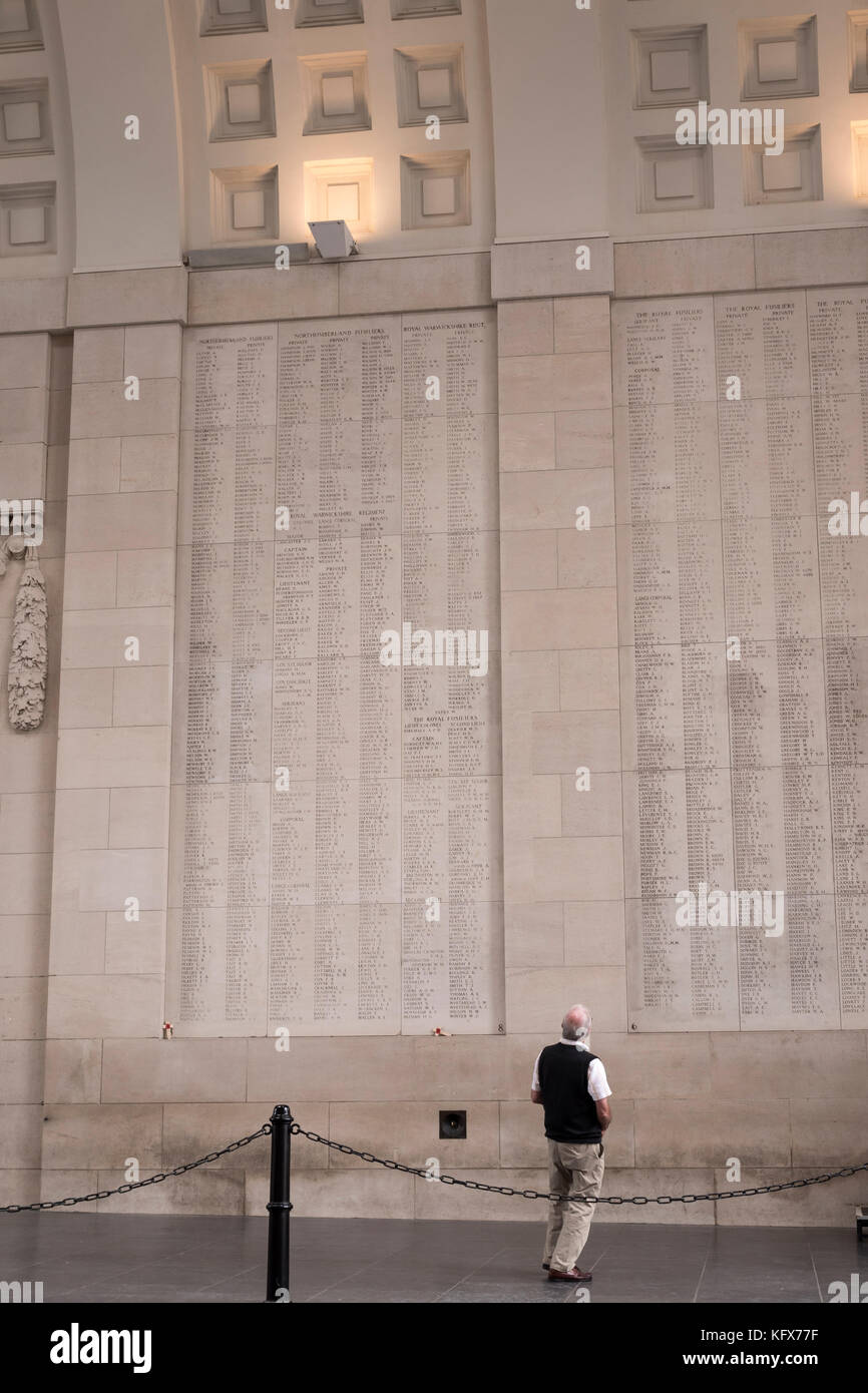 Man looking at the inscriptions on the Menin Gate World War 1 Memorial ...