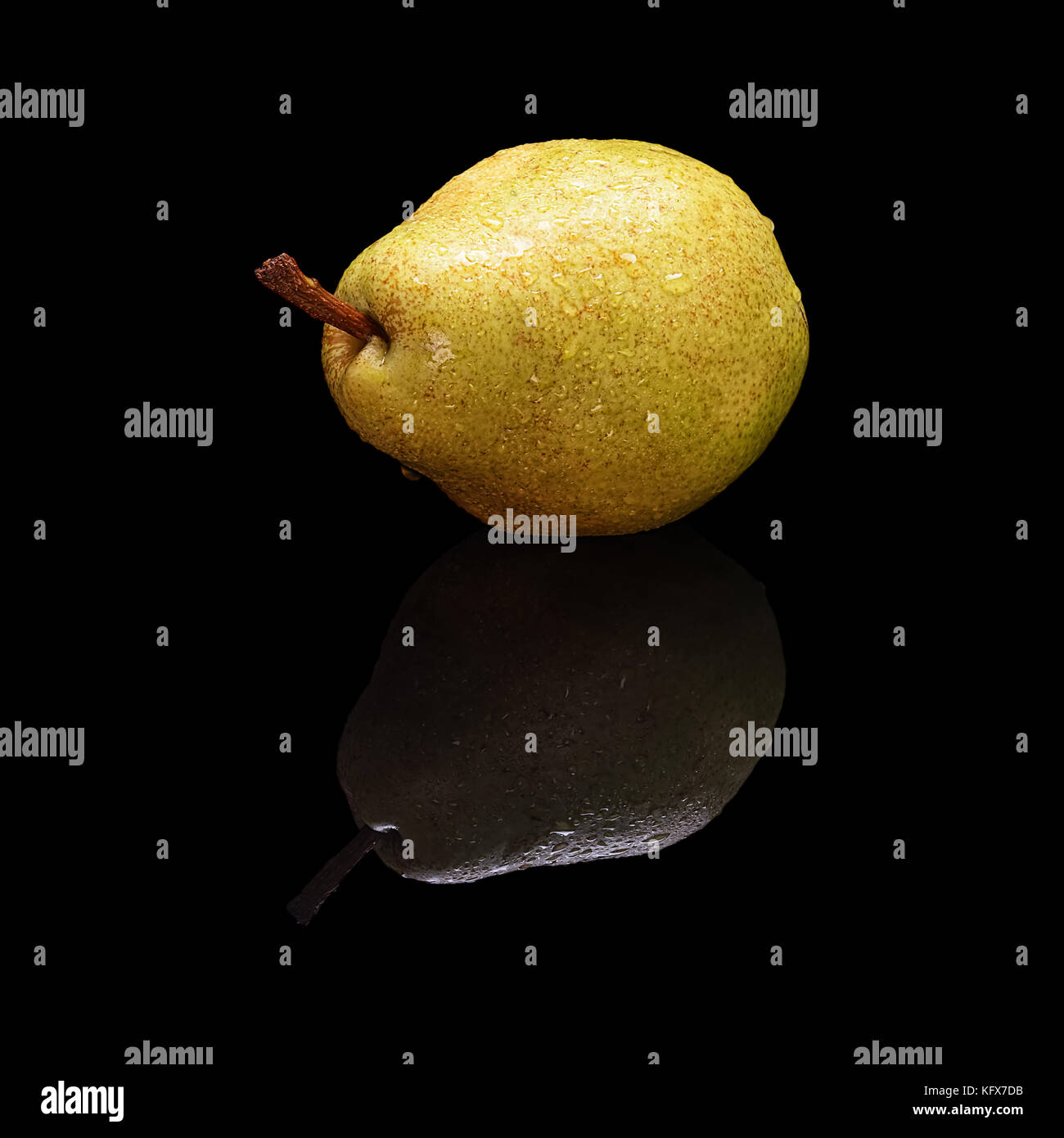One whole lying ripe pears isolated on black glossy background with ...