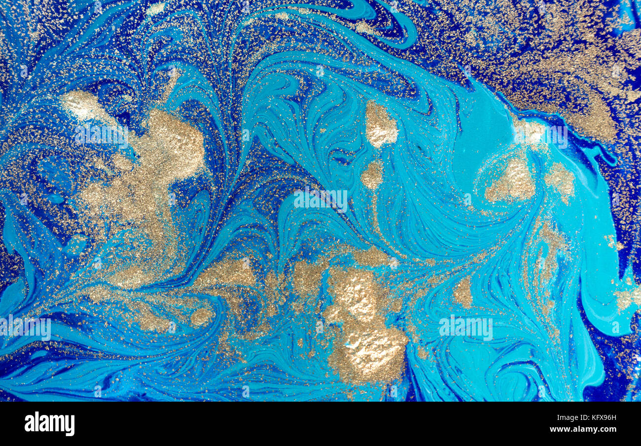 Marbled blue abstract background with golden sequins. Liquid marble ink ...