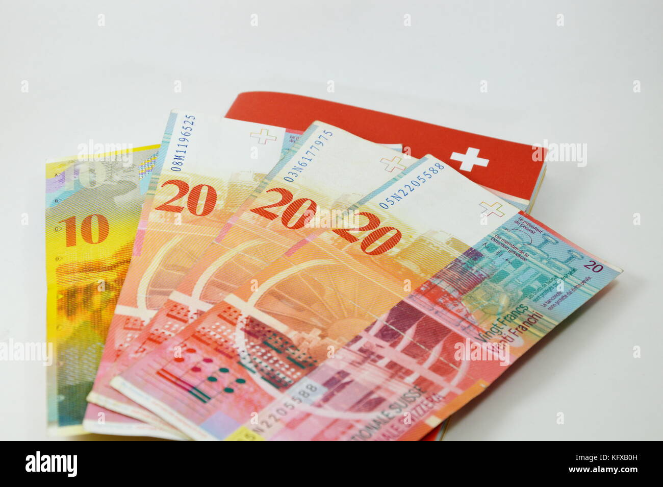 Swiss money on red book in white background Stock Photo - Alamy