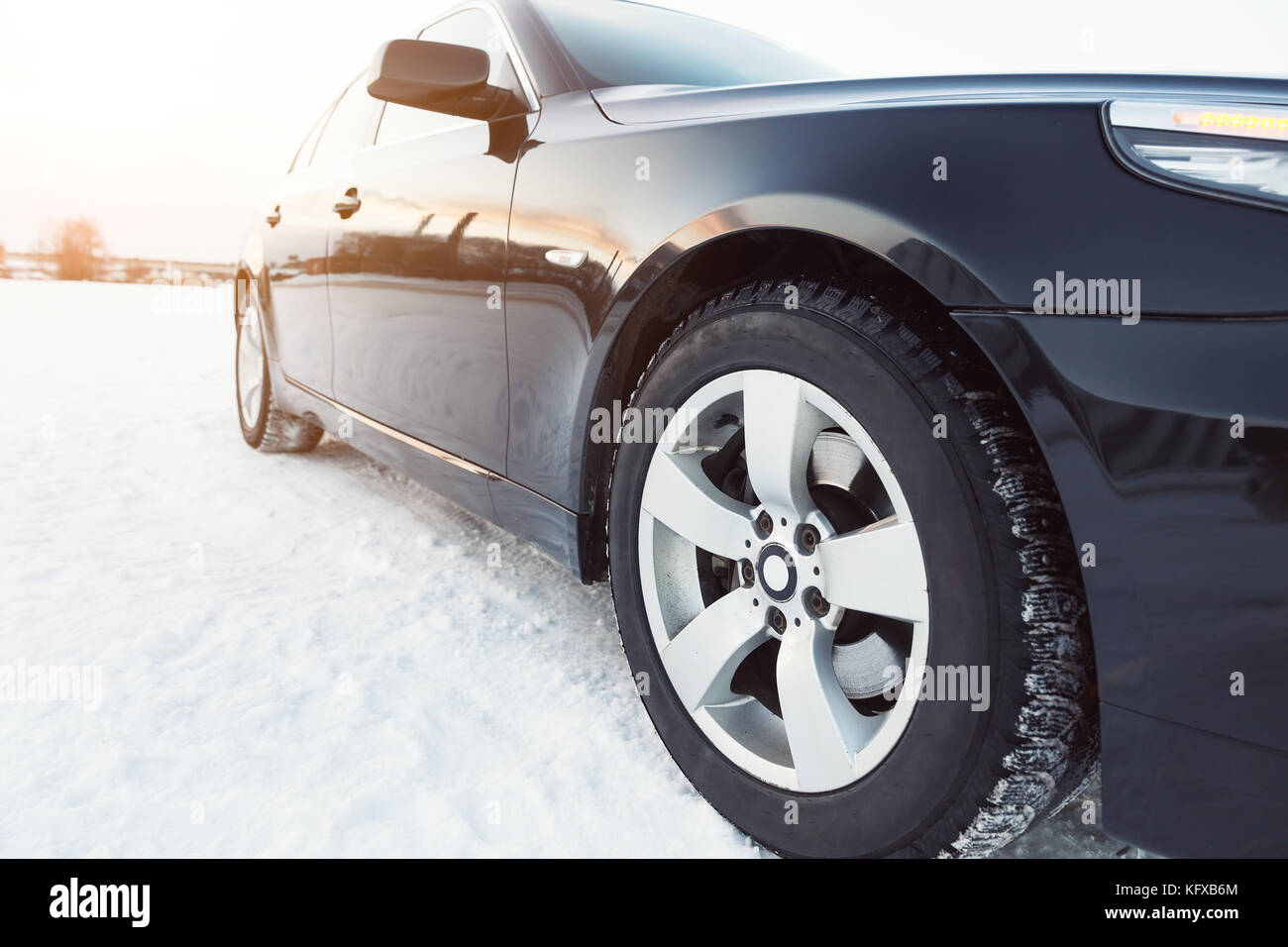 Close up of car tires on the winter road with snow Stock Photo - Alamy