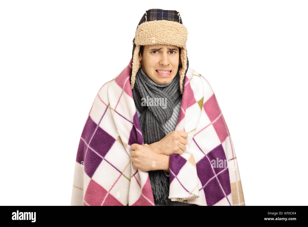 Young man covered with a blanket feeling cold isolated on white ...