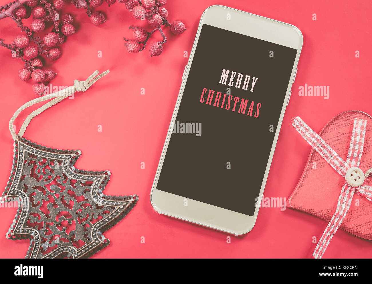 Christmas smart phone on red background Stock Photo - Alamy