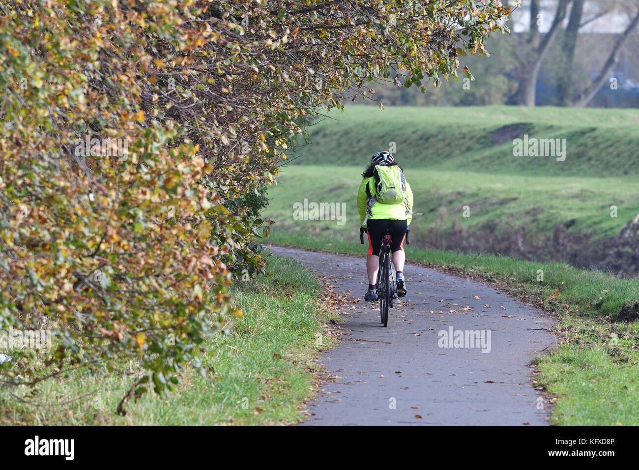 A cyclist cycles along a path by the River Mersey, Heaton Mersey ...