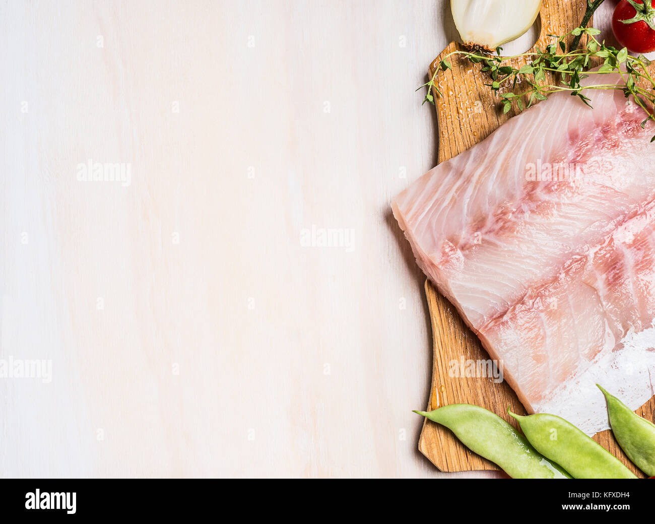 Food background with Raw fish fillet and fresh seasoning on white ...