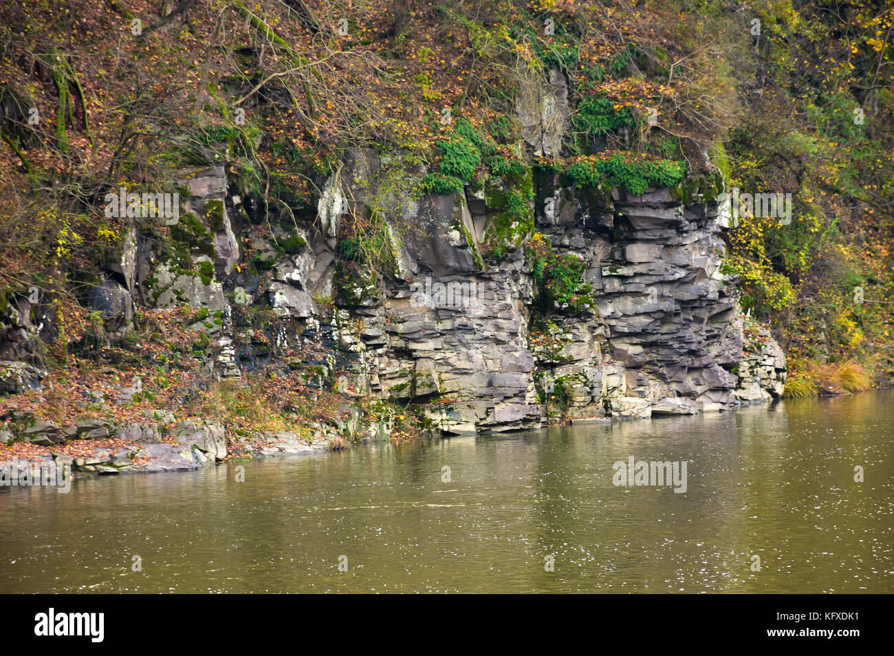 rocky cliff over the river in forest. beautiful autumn background with ...