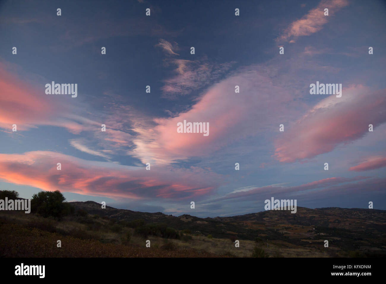 Pink clouds forming over the Greek sky, during sunset hour Stock Photo ...