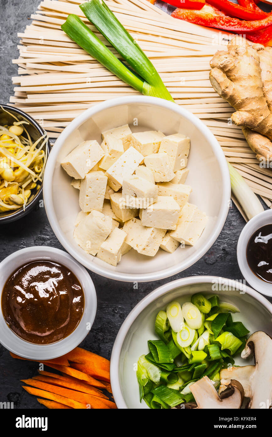 Asian food ingredients: tofu, noodles, ginger, cut vegetables, Sprout ...