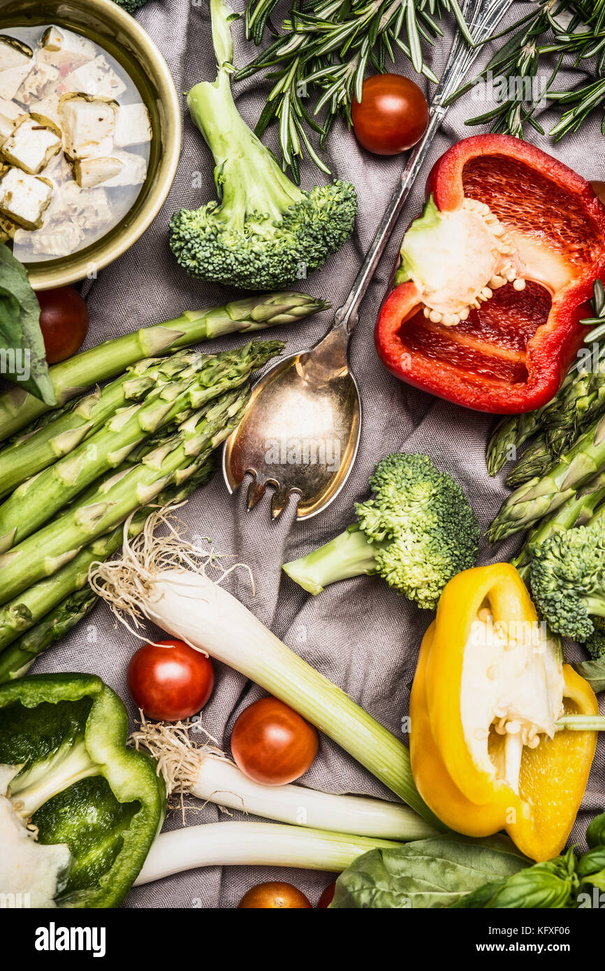 Various colorful vegetables ingredients with cooking spoon and feta ...