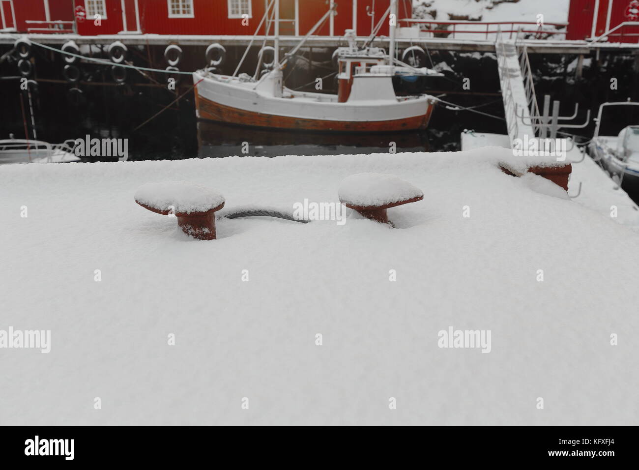 Snow covered harbor of Nusfjord fishing village with floating pontoons ...