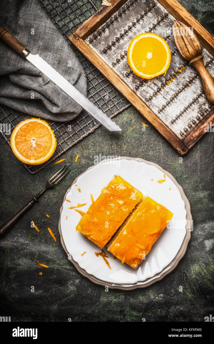 Orange cakes with orange topping on rustic table with fresh orange peel ...
