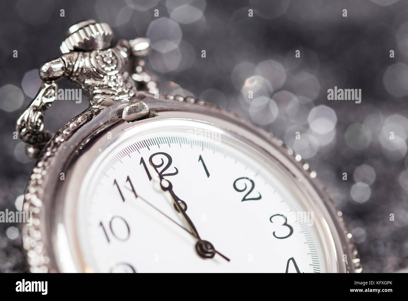 New Year's at midnight - Old pocket watch on silver background Stock ...