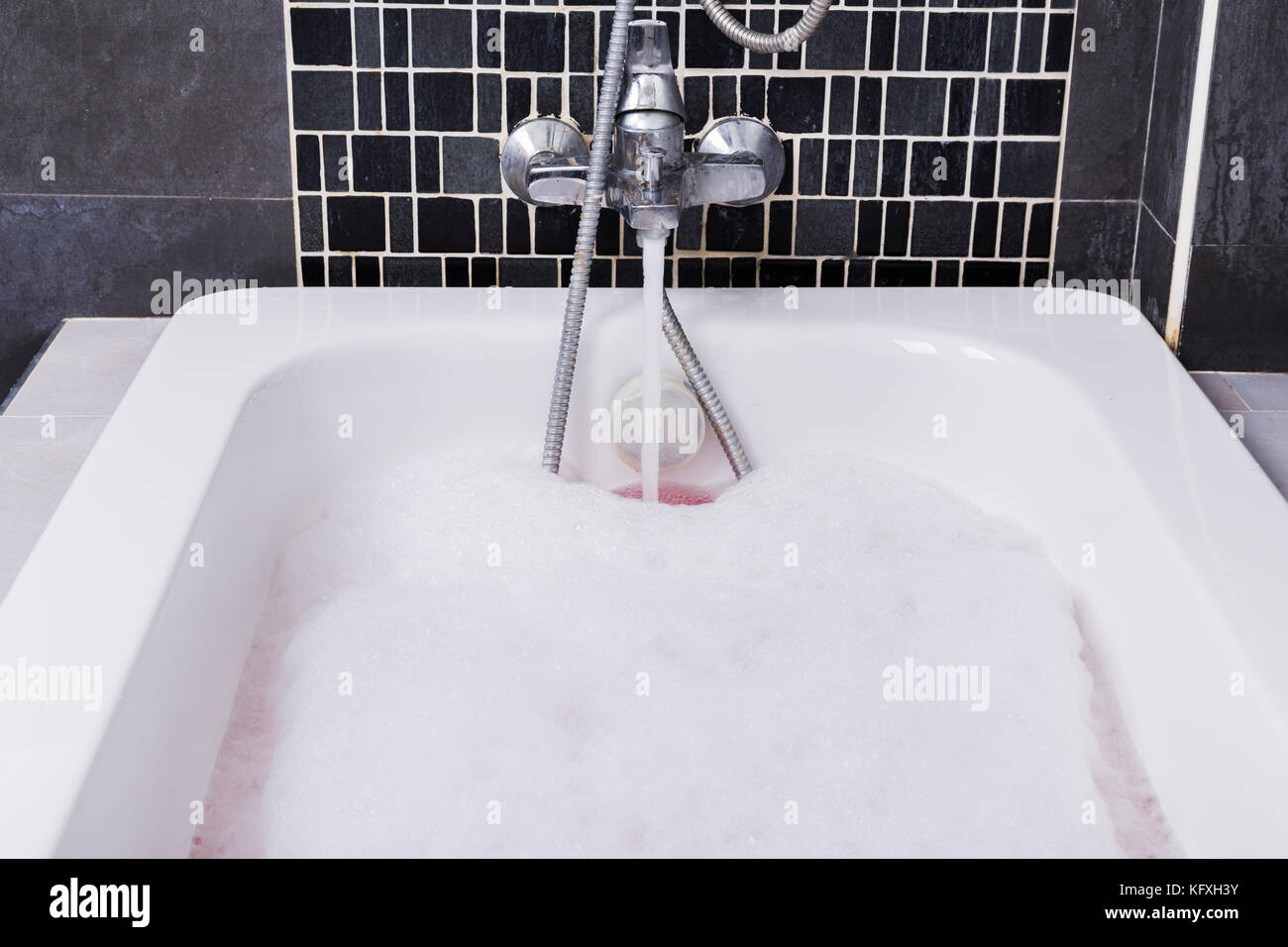 white modern bathtub with bubble bath in the bathroom Stock Photo - Alamy