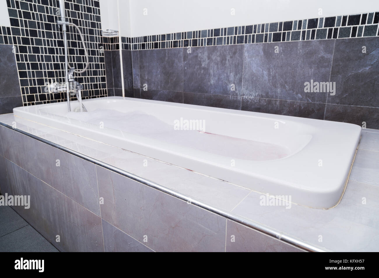 white modern bathtub with bubble bath in the bathroom Stock Photo - Alamy
