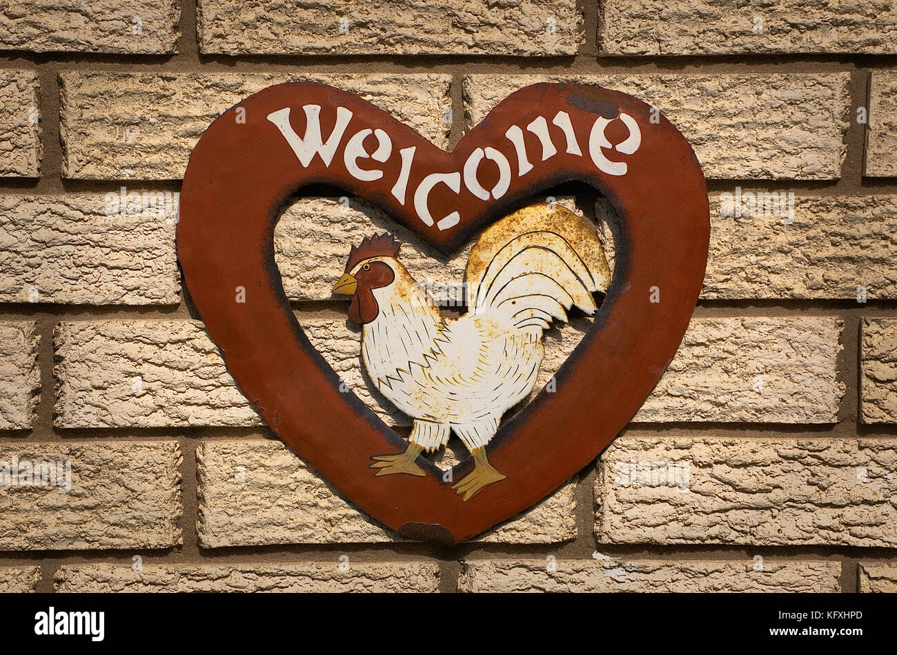 Artistic metal welcome sign on a brick wall of a home Stock Photo - Alamy