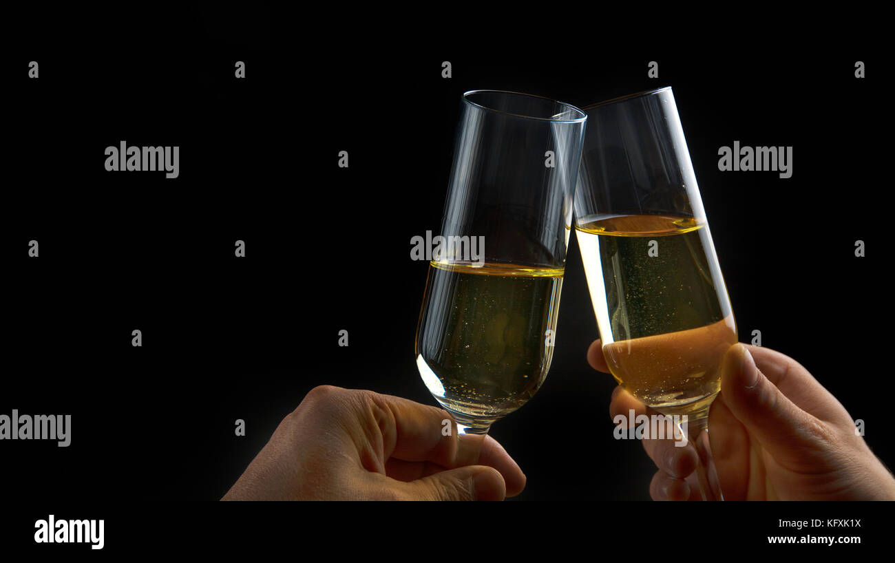 making a toast with champagne glasses in black background Stock Photo ...