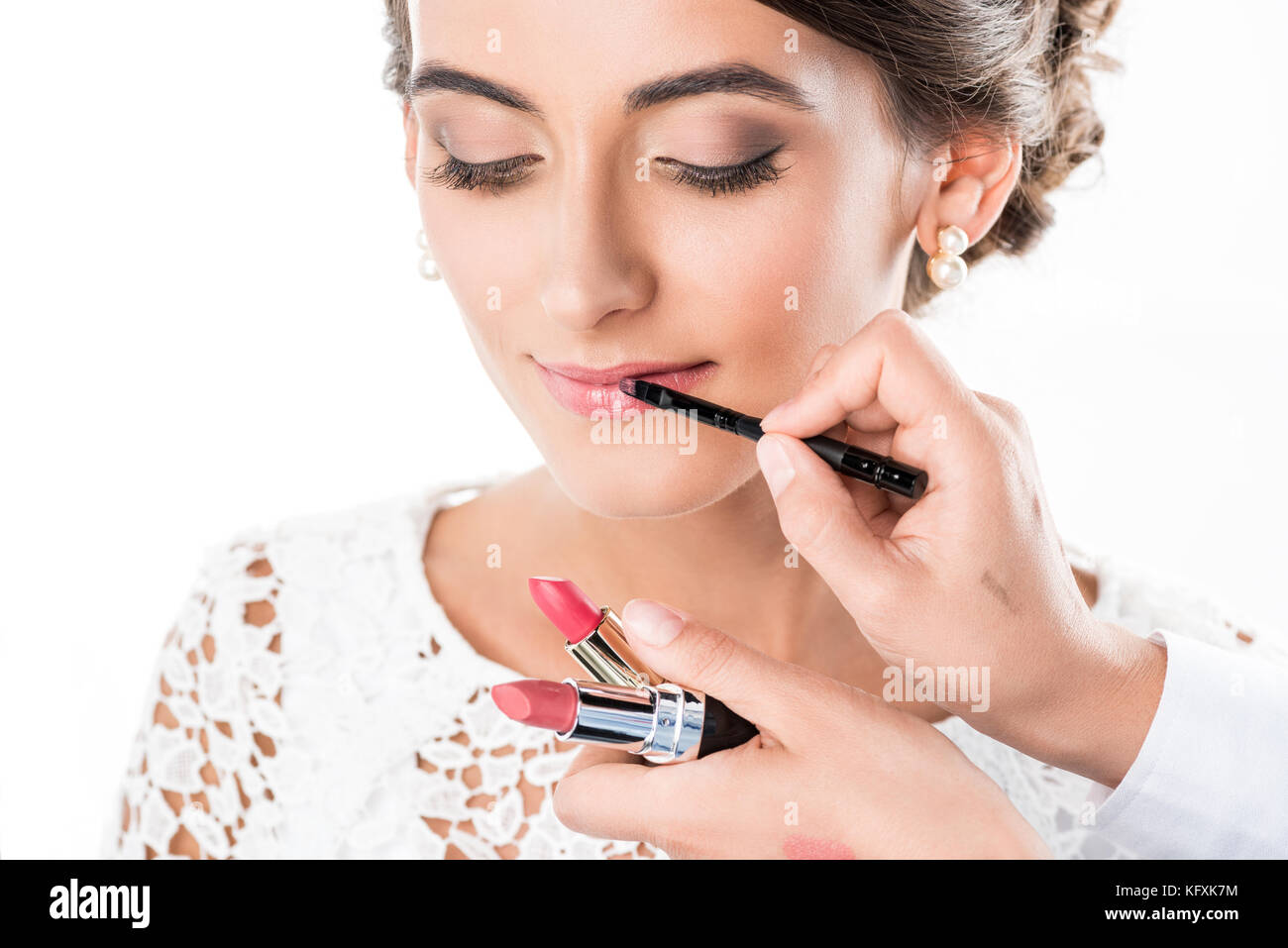 makeup artist applying lipstick on model Stock Photo - Alamy