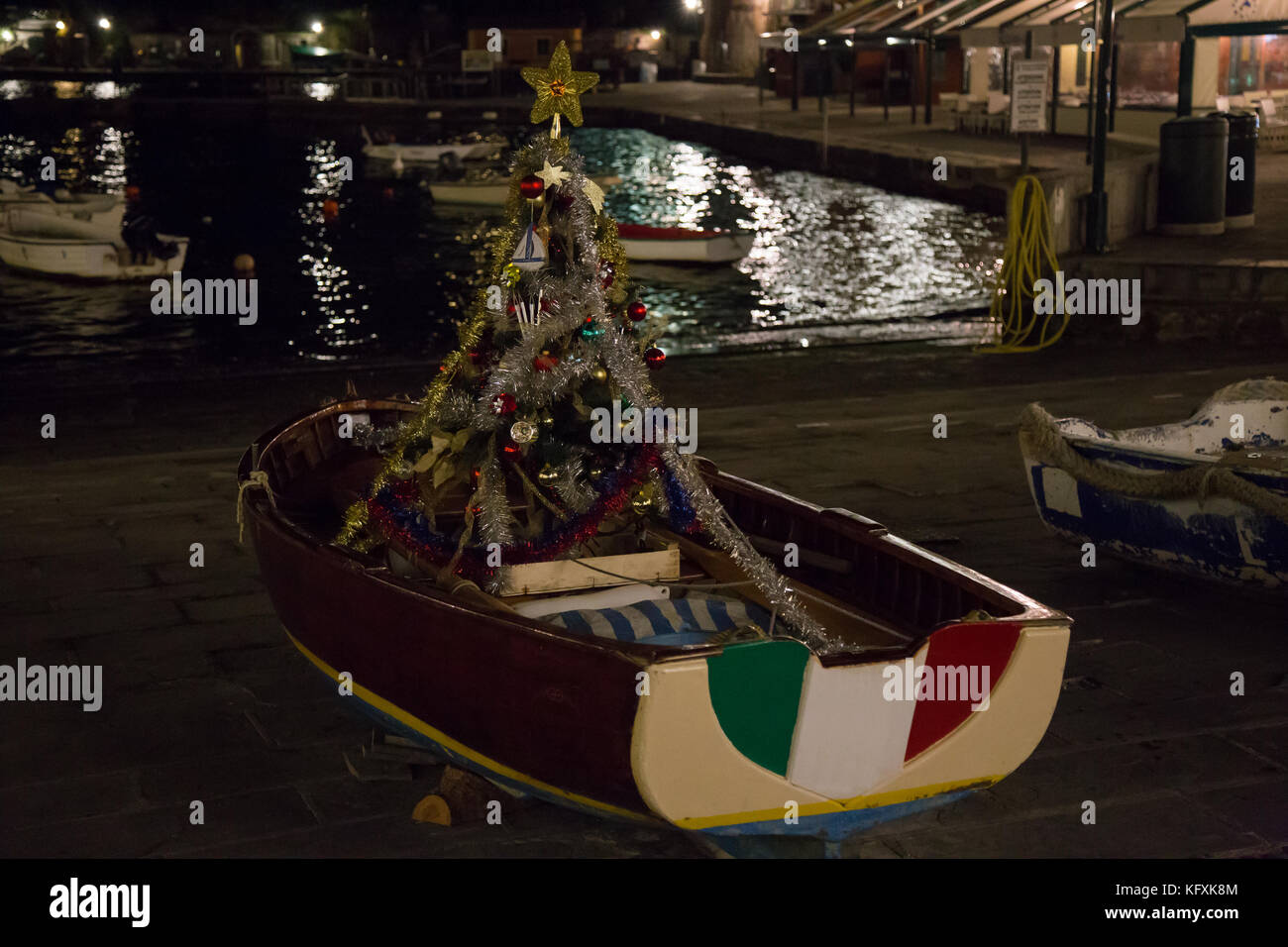 Small fishing boat with a Christmas tree inside Stock Photo - Alamy