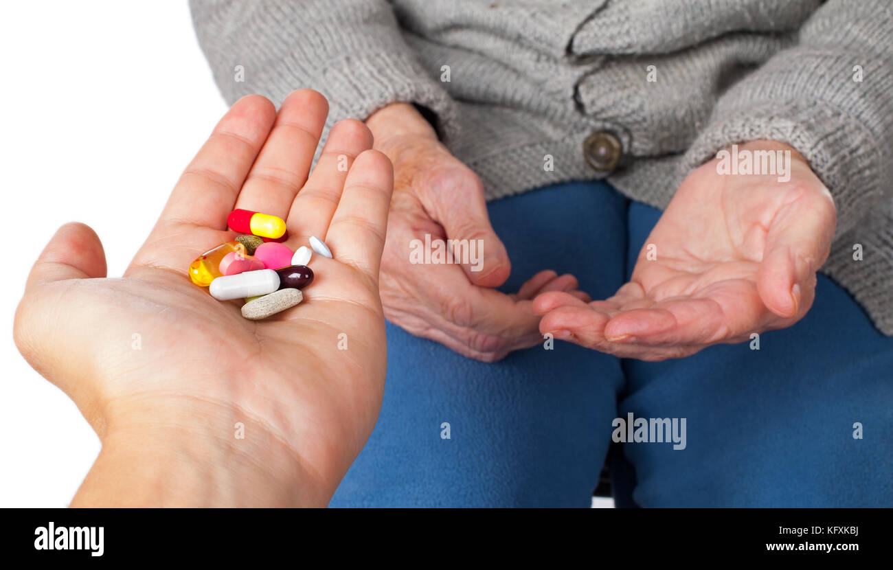 Close up picture of a doctor hand giving pills to a senior woman Stock ...