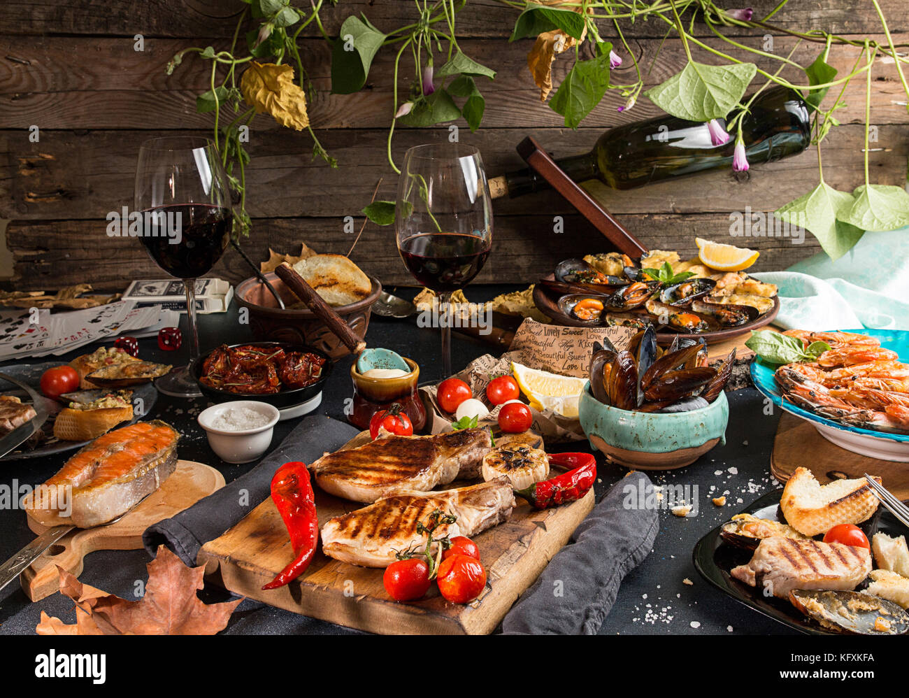 Overhead of dinner table. Assorted delicious grilled barbecue meat and ...