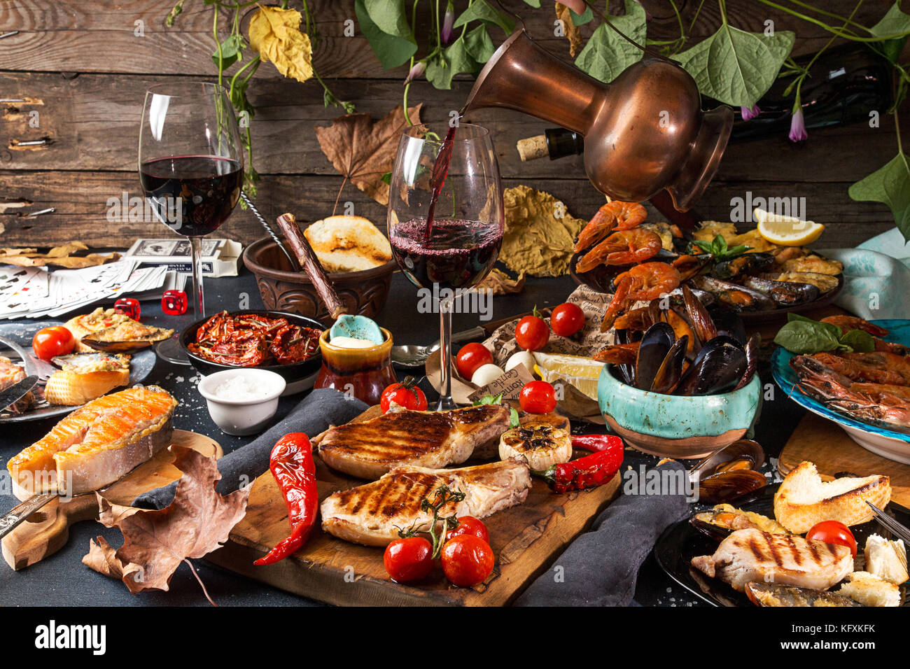 Overhead of dinner table. Assorted grilled barbecue meat and seafood ...