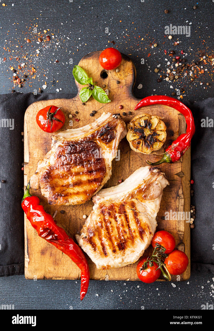 Overhead of dinner table. Delicious grilled barbecue pork meat on old ...