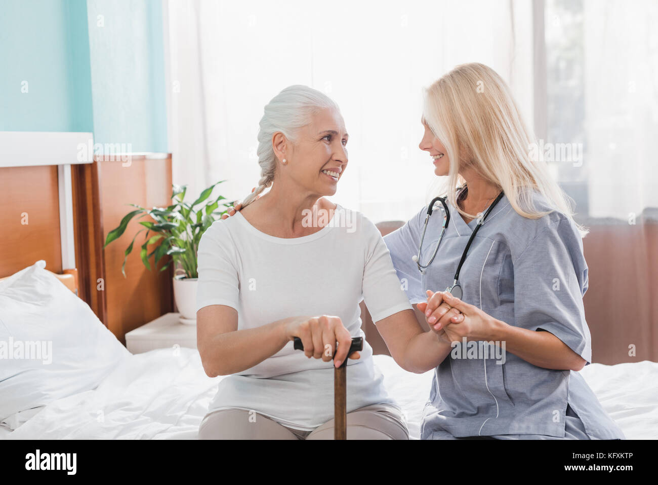 nurse and senior woman with cane Stock Photo - Alamy