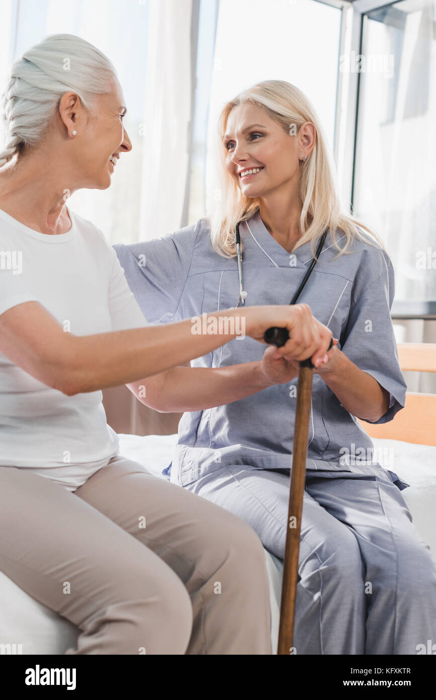 nurse and senior woman with cane Stock Photo - Alamy