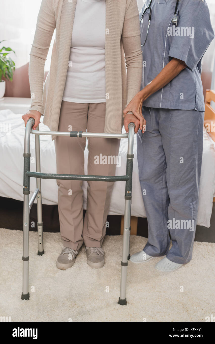 nurse and senior patient with walker Stock Photo - Alamy