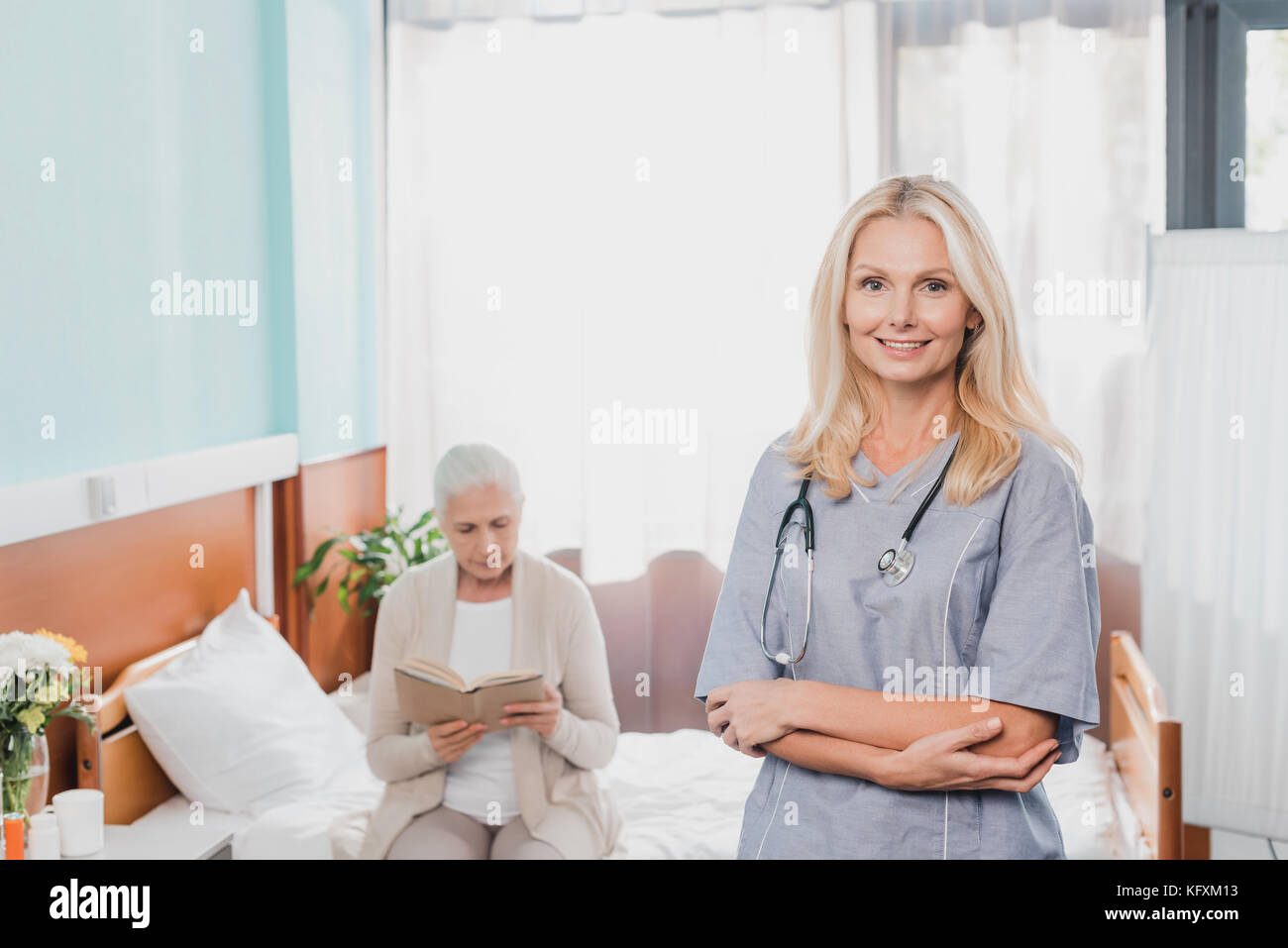 nurse and senior patient with book Stock Photo - Alamy