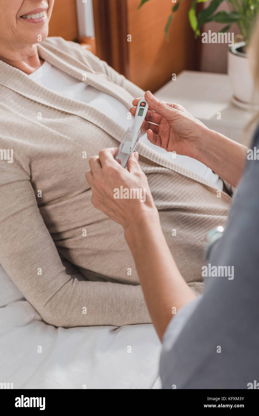 nurse measuring temperature of patient Stock Photo - Alamy