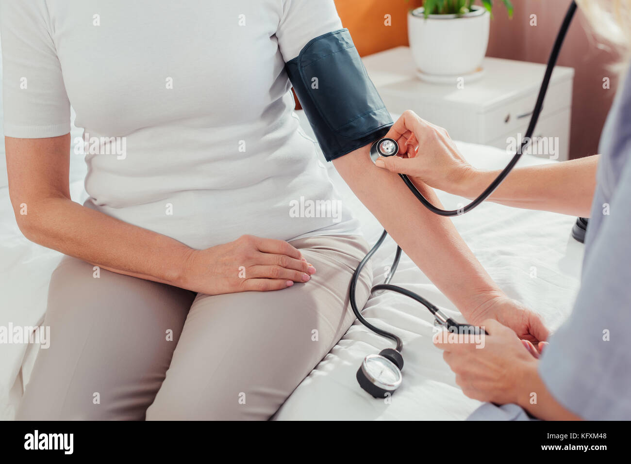 nurse measuring blood pressure to patient Stock Photo - Alamy