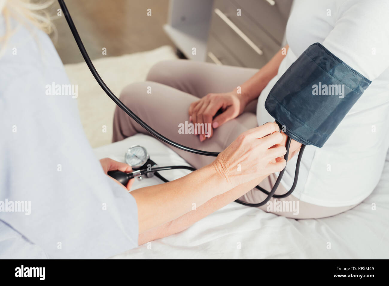 nurse measuring blood pressure to patient Stock Photo - Alamy