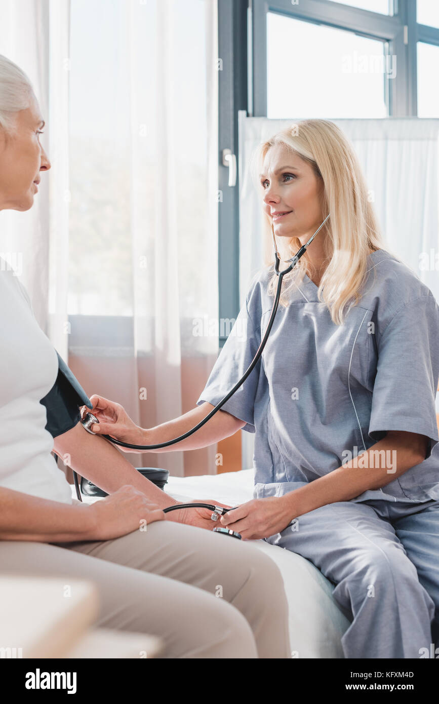 nurse measuring blood pressure to patient Stock Photo - Alamy