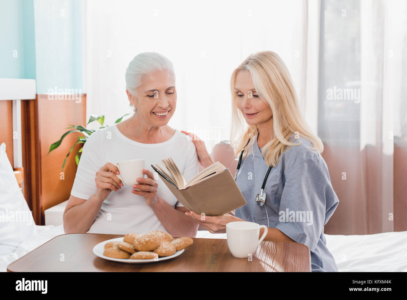 nurse and patient reading book Stock Photo - Alamy