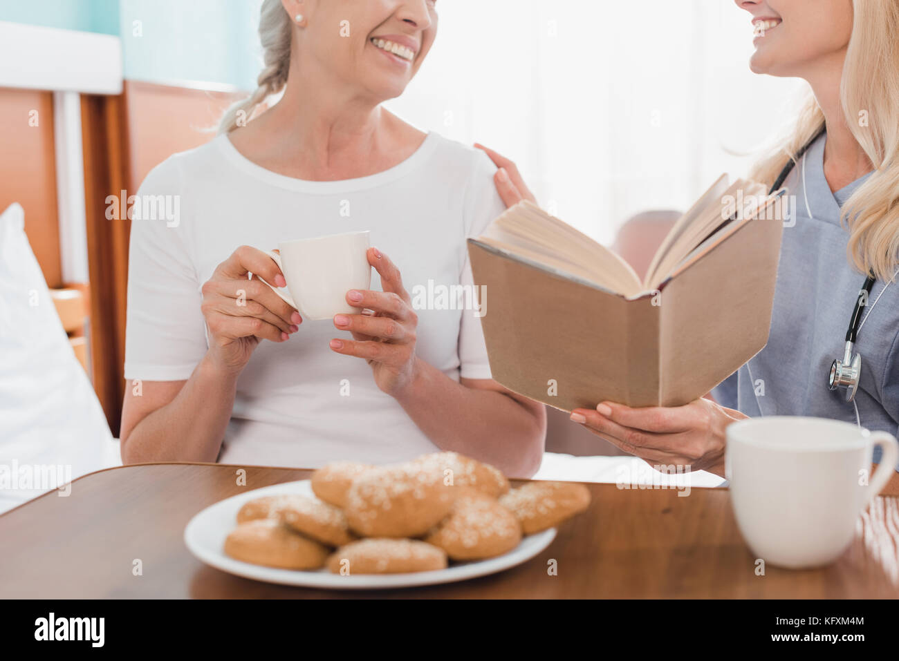 nurse and patient reading book Stock Photo - Alamy