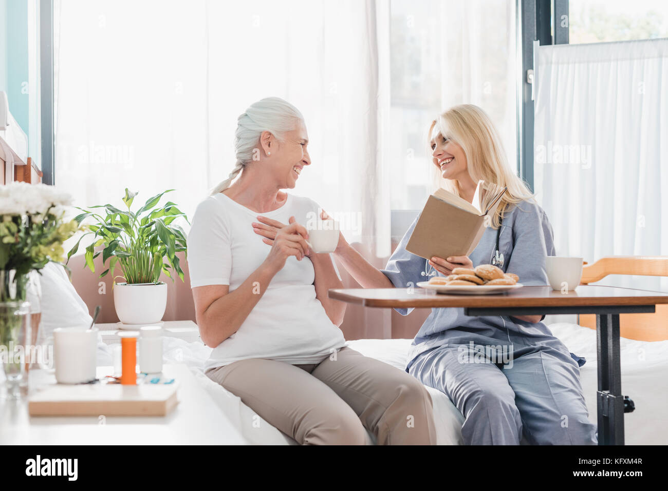 nurse and patient reading book Stock Photo - Alamy