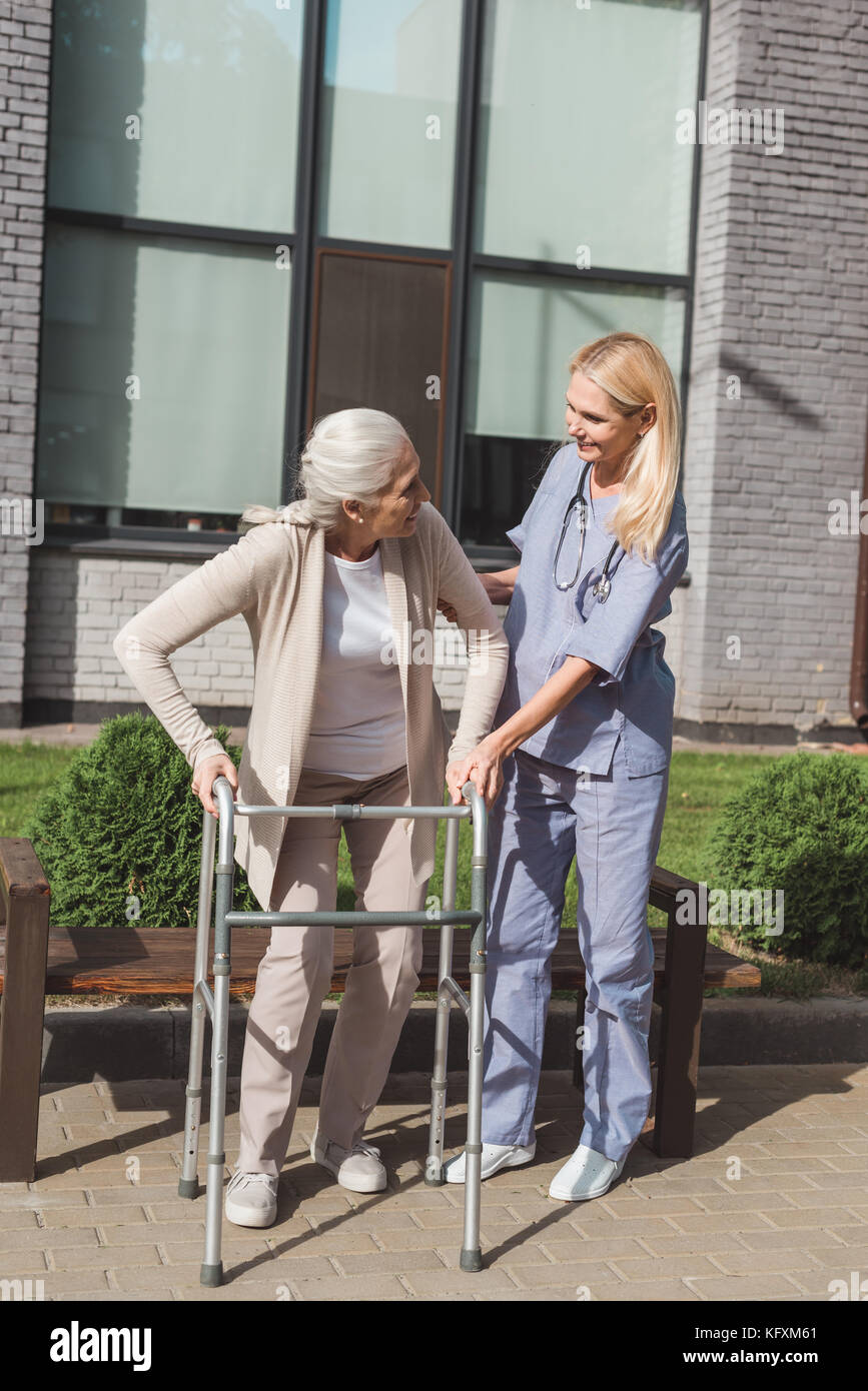 nurse and senior patient with walker Stock Photo - Alamy